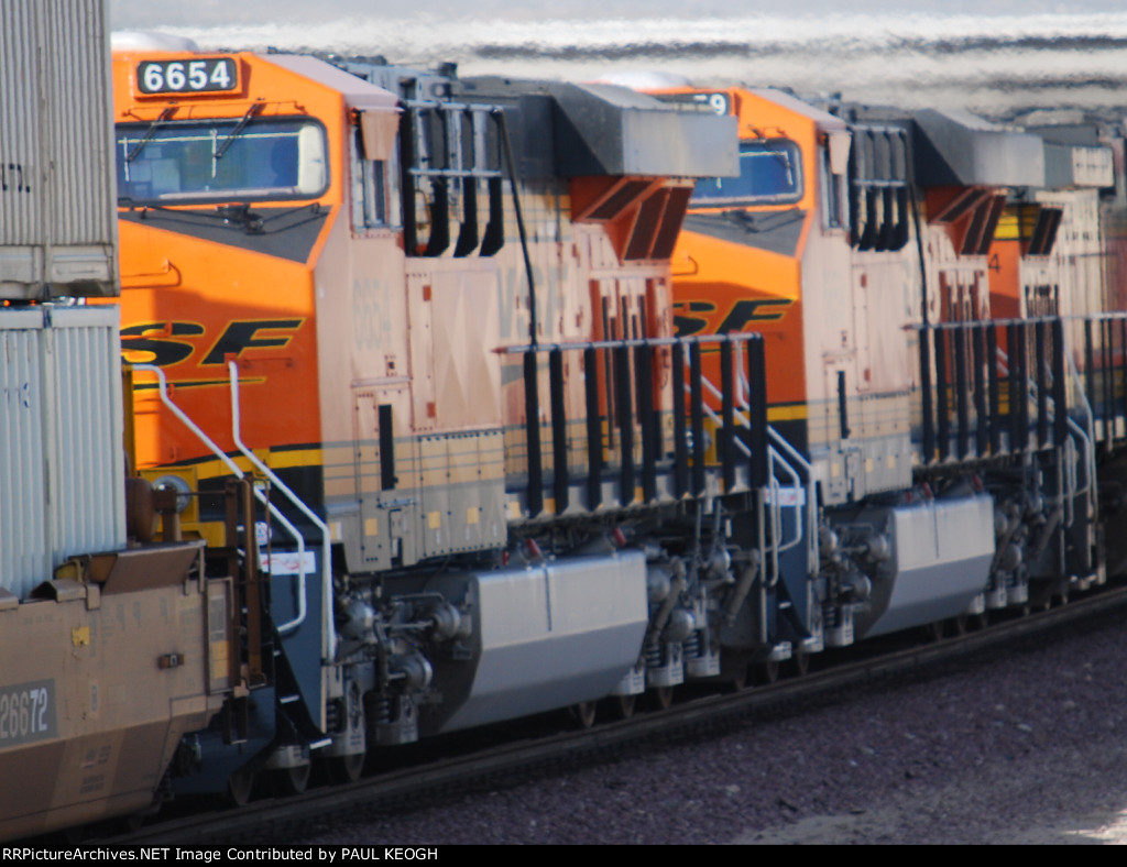 Close in off the previous shot of BNSF 6654 and BNSF 6659 as they pull a Hot Z as the #4 and #3 ...